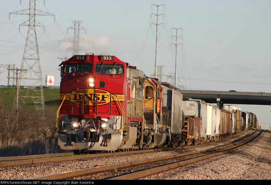 Wearing fresh warbonnet paint, BNSF 933 leads a northbound freight out of the former BN North ...